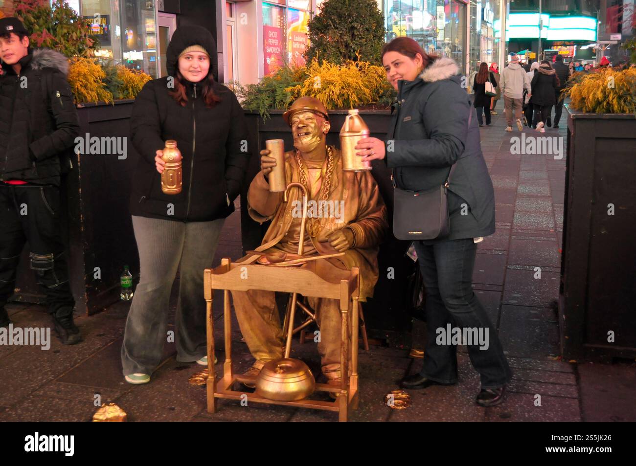 People pose next to a street performer, center, in Times Square ...