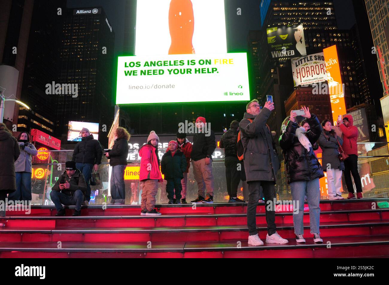 People are seen on red stairs in Times Square, Manhattan, New York City ...