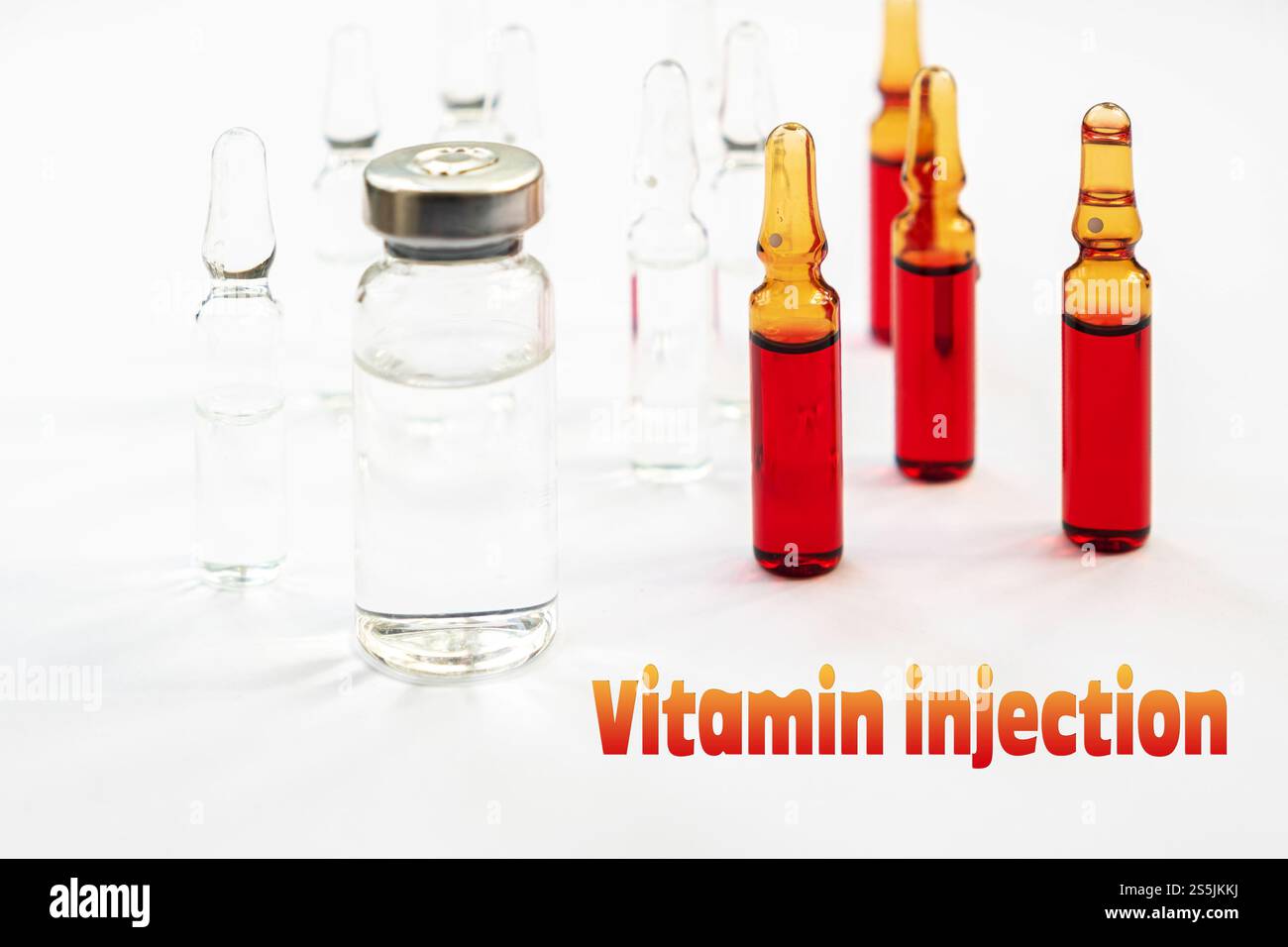 Inscription vitamin injection. Ampoules with red and transparent liquid ...