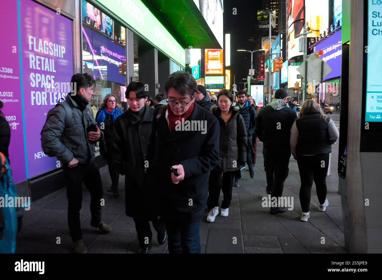 People walk through Times Square, Manhattan, New York City. (Photo by ...