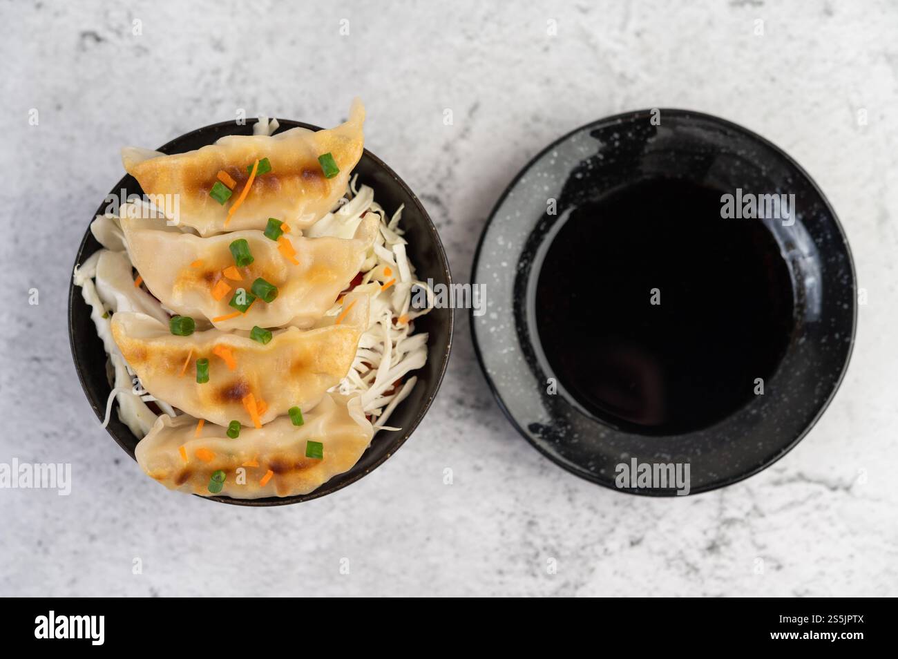 Black plate gyoza dumplings soy hi-res stock photography and images - Alamy