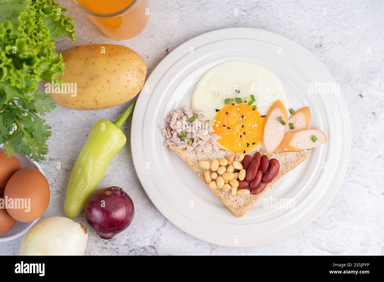 Breakfast consists of fried eggs, sausage, minced pork, bread, red ...