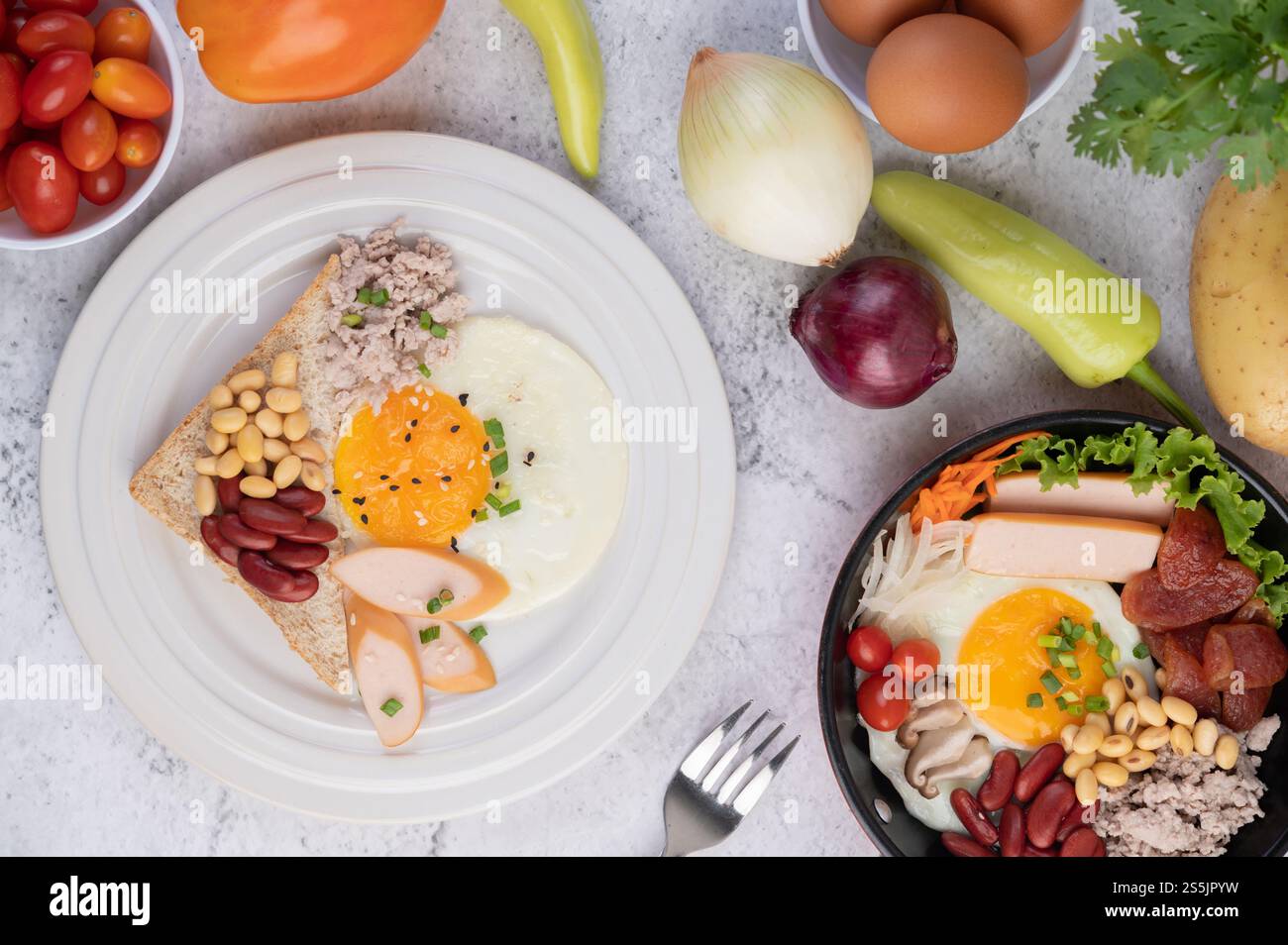 Breakfast consists of fried eggs, sausage, minced pork, bread, red ...