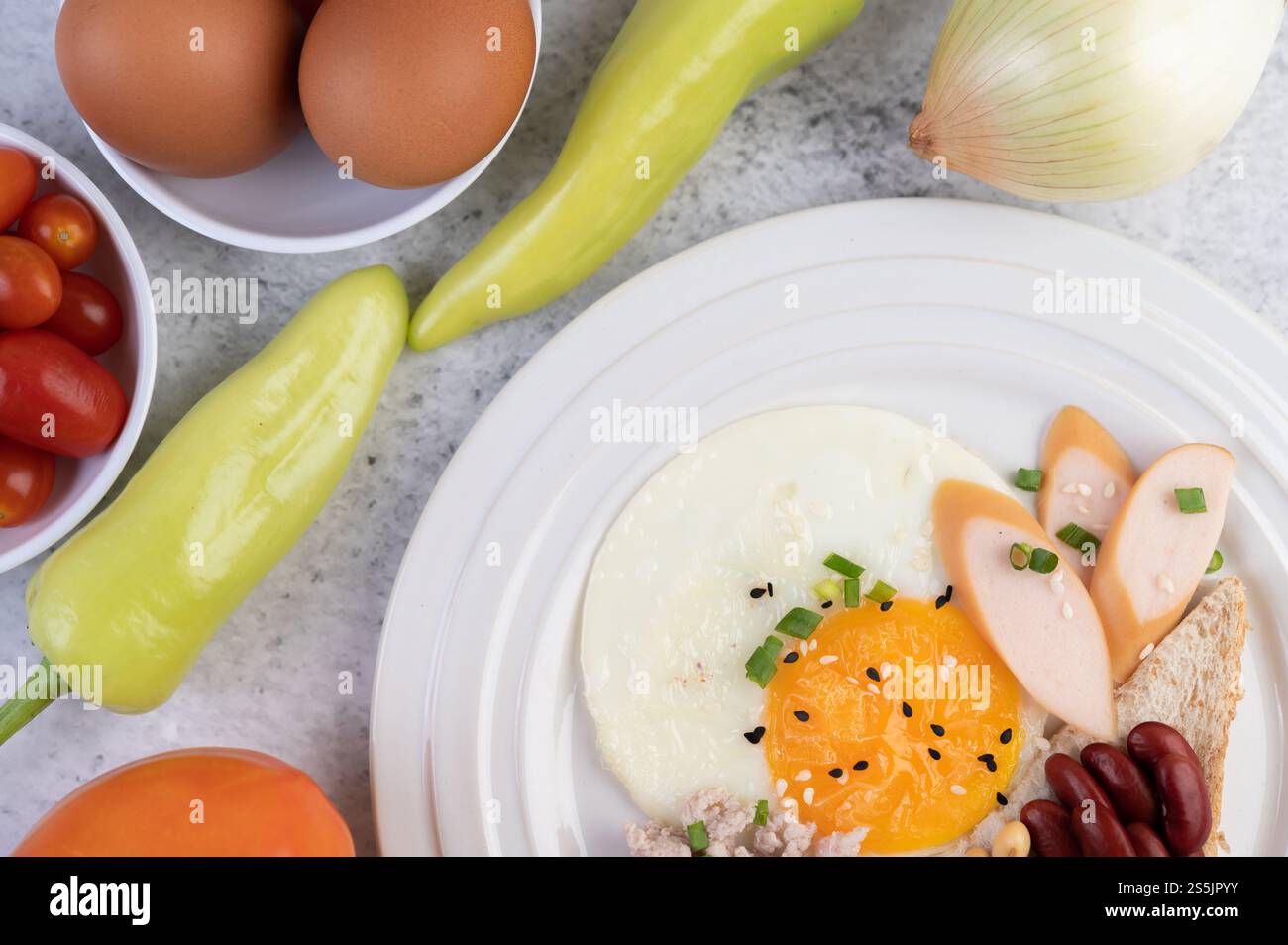 Breakfast consists of fried eggs, sausage, minced pork, bread, red ...