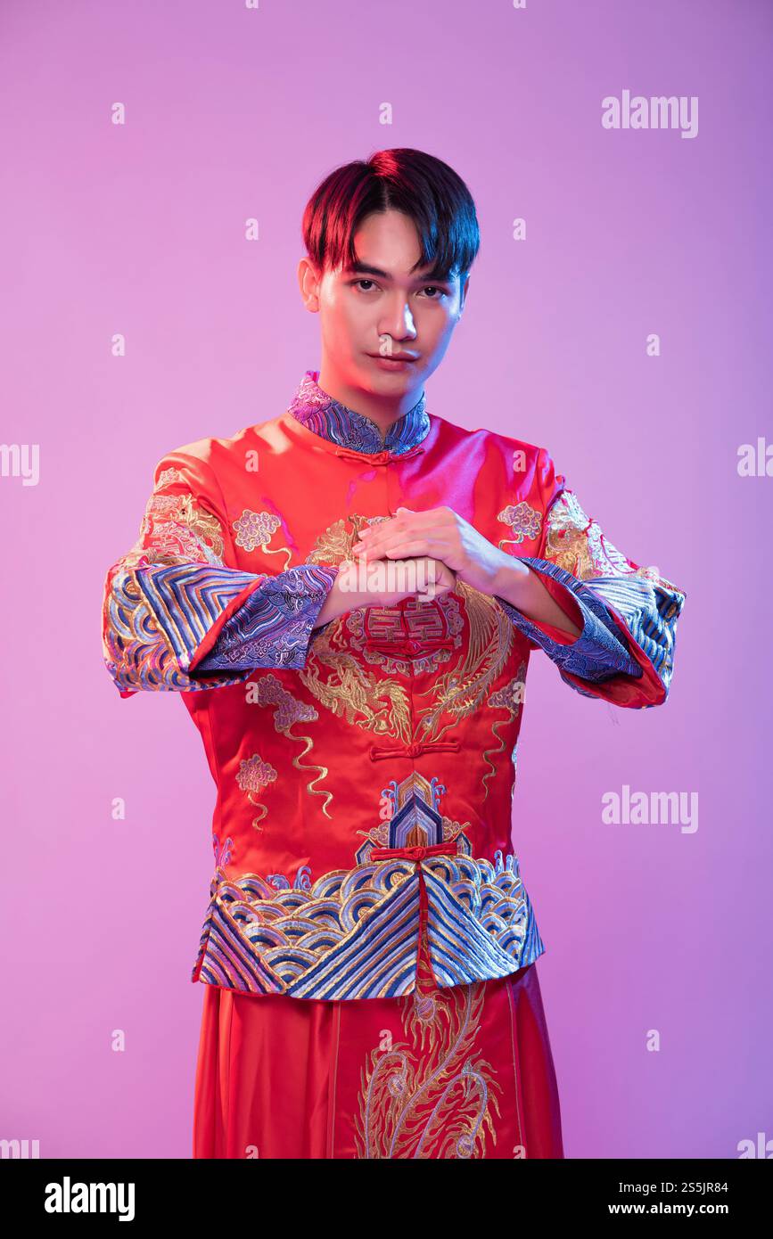 A man wear cheongsam is standing and respect customer who come to shop ...