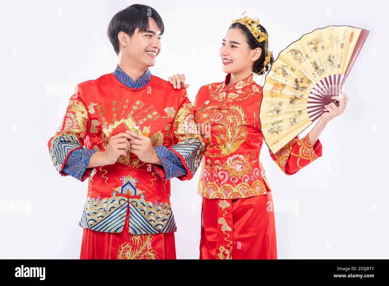 Chinese new year, man and woman wear cheongsam smiling to welcome good ...