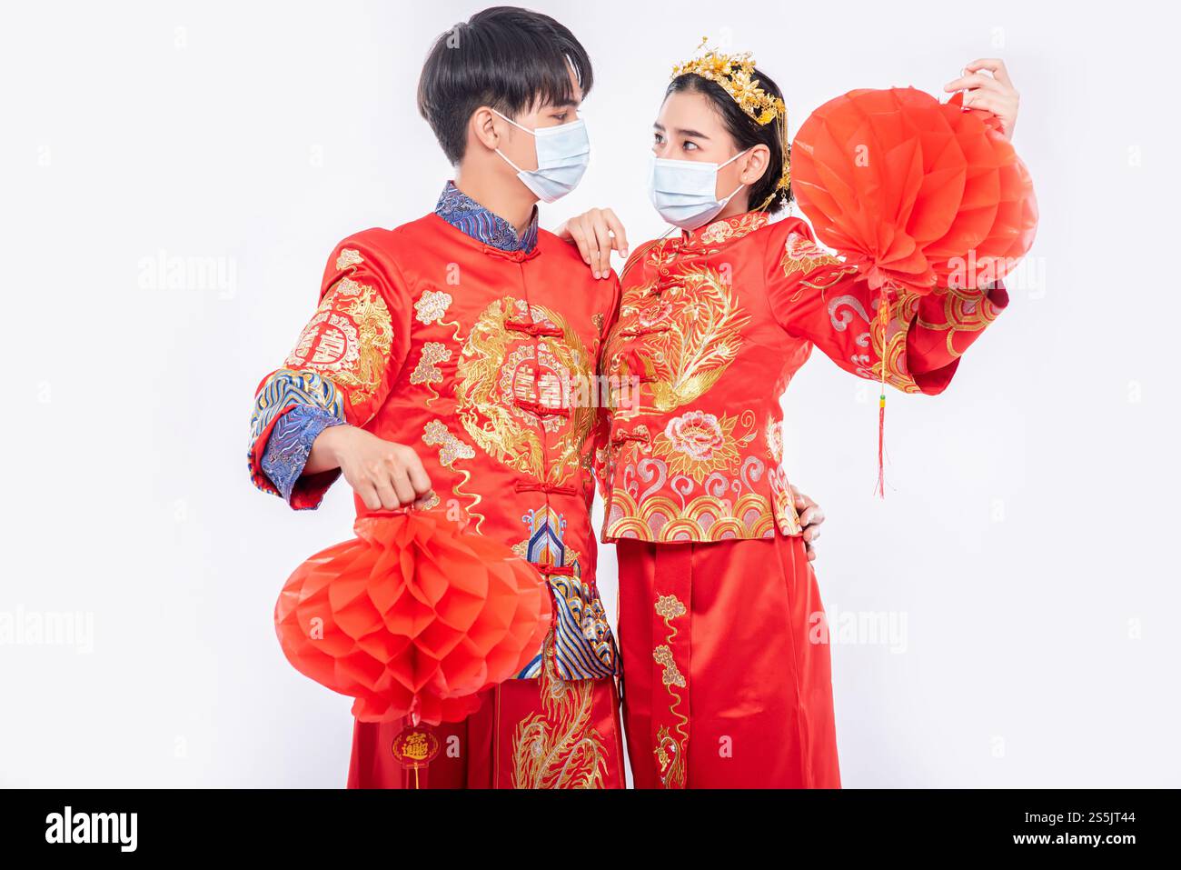 Men and women wearing qipao and wearing face masks Stand with honeycomb ...