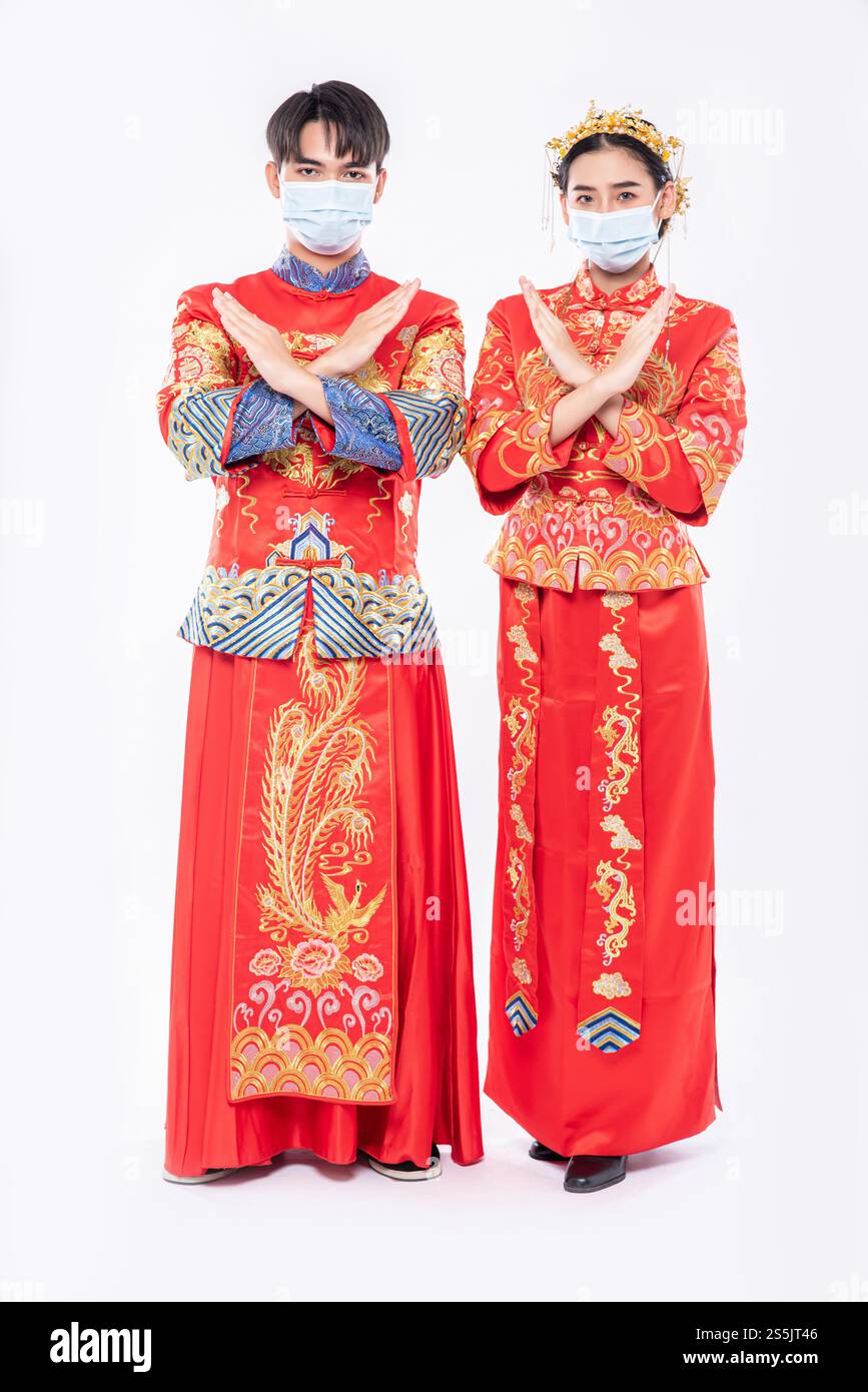 Man and woman wear Cheongsam suit and mask expression to stop spread ...
