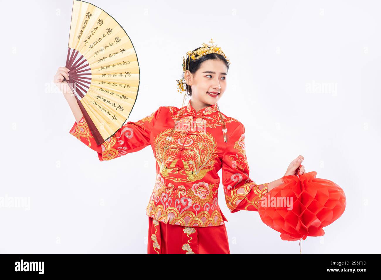Woman wear Cheongsam suit hold the chinese hand fan and red lamp to ...
