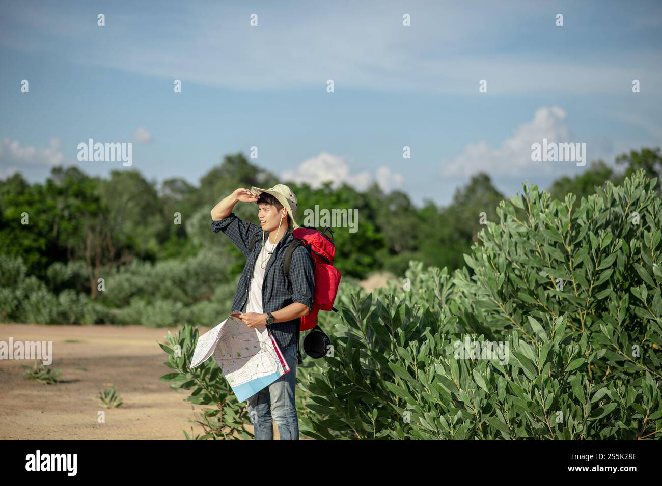 Young backpacker man traveler with map, He carry large backpack during ...