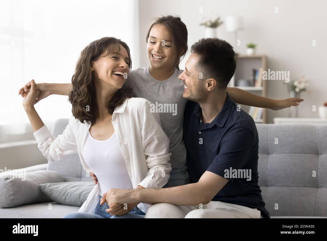 Happy mom and dad spend time with cute preschooler daughter Stock Photo ...