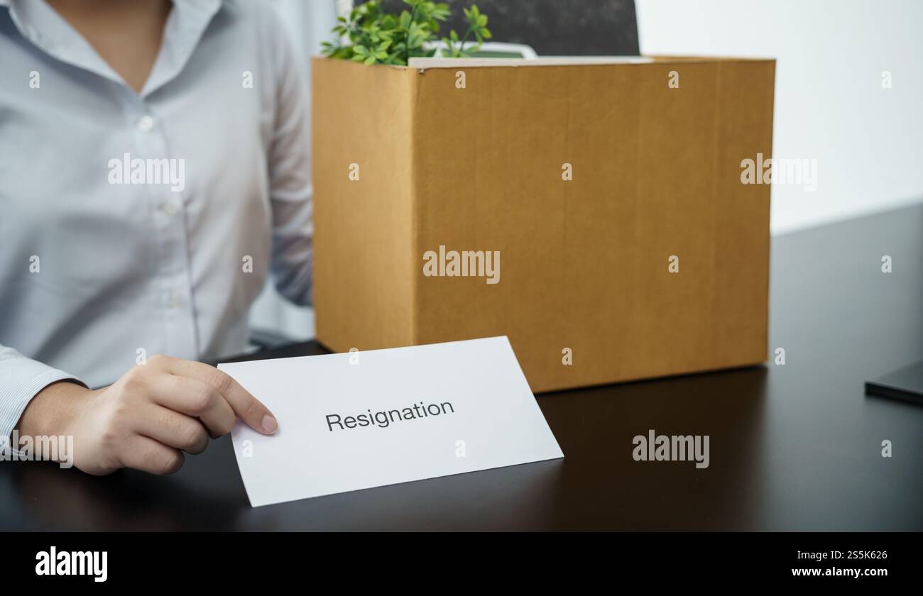 Business woman sending resignation letter to boss and Holding Stuff ...