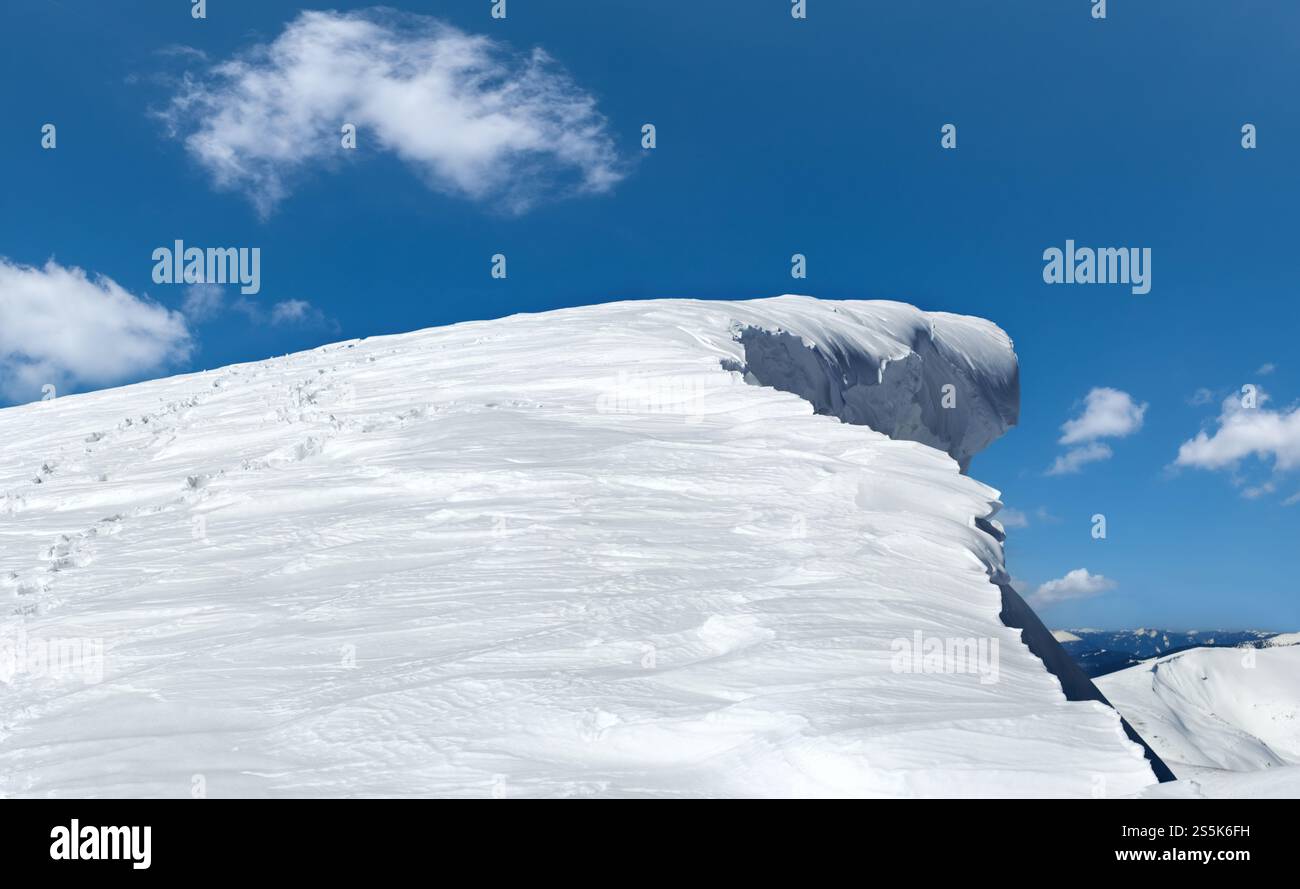 Winter mountain top with fairy overhang snow cap and human footprint on ...