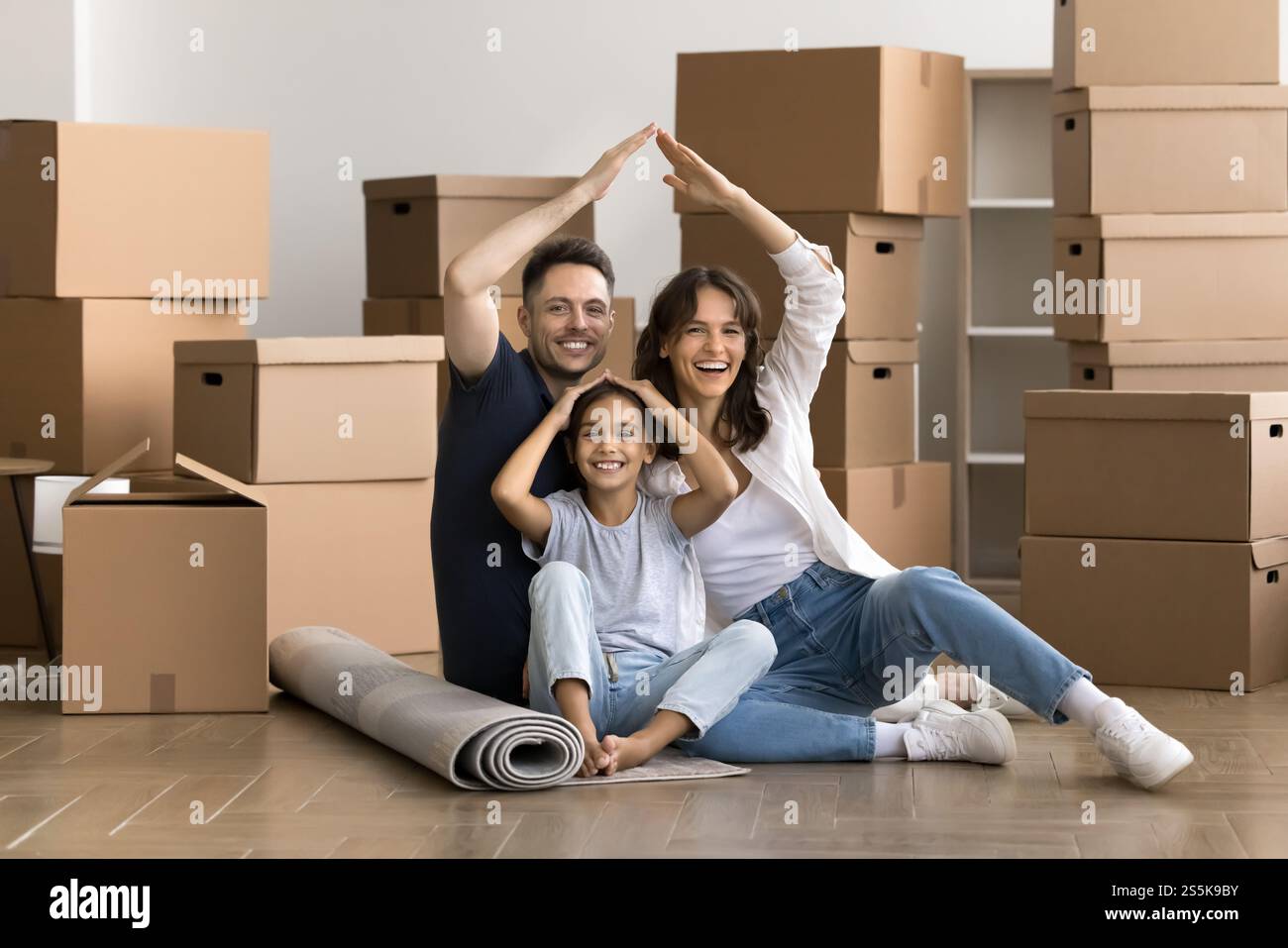 Happy homeowner family with little daughter celebrate relocation day ...