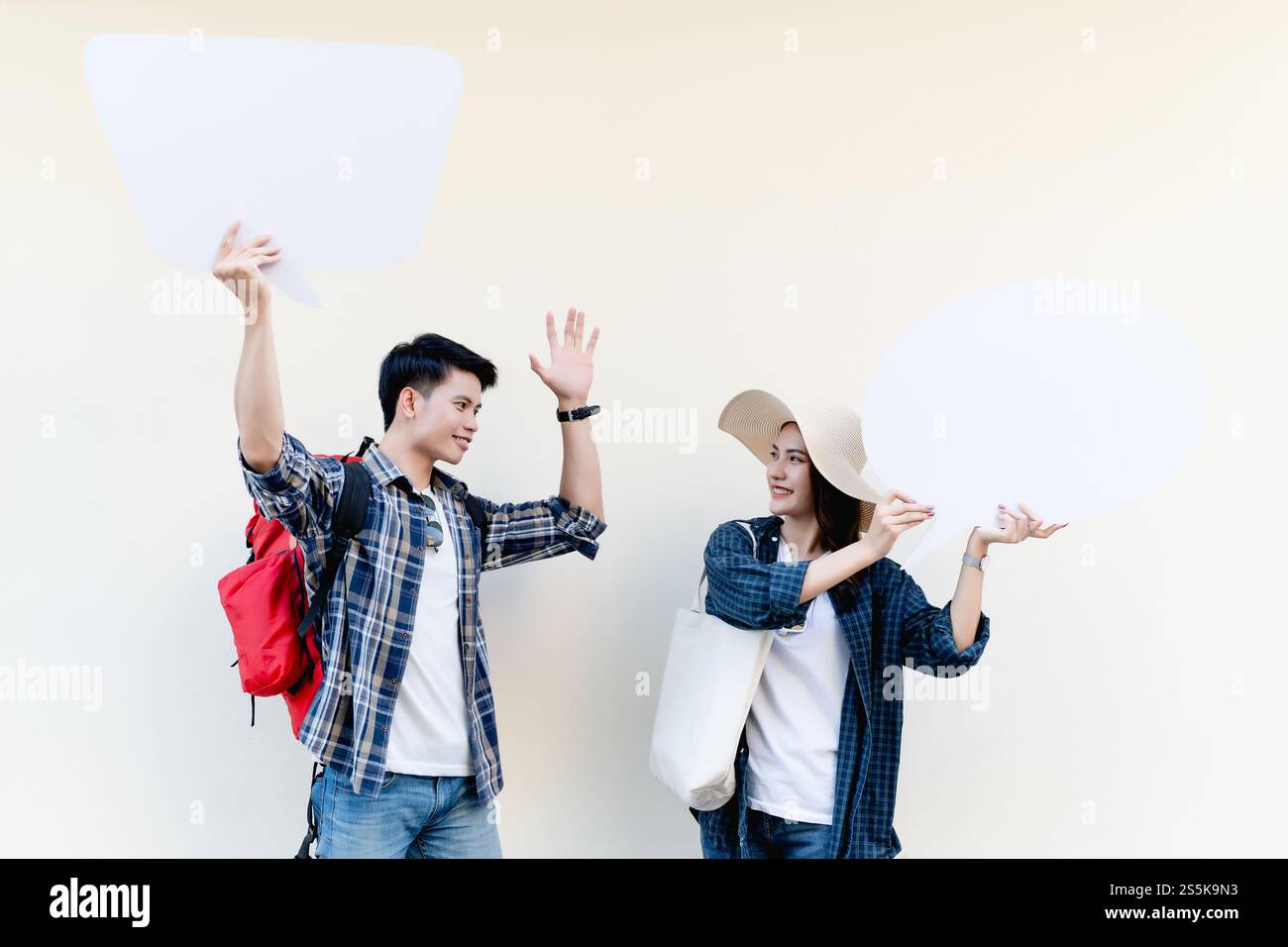 Young backpacker couple holding balloon speed mock up and smile on city ...