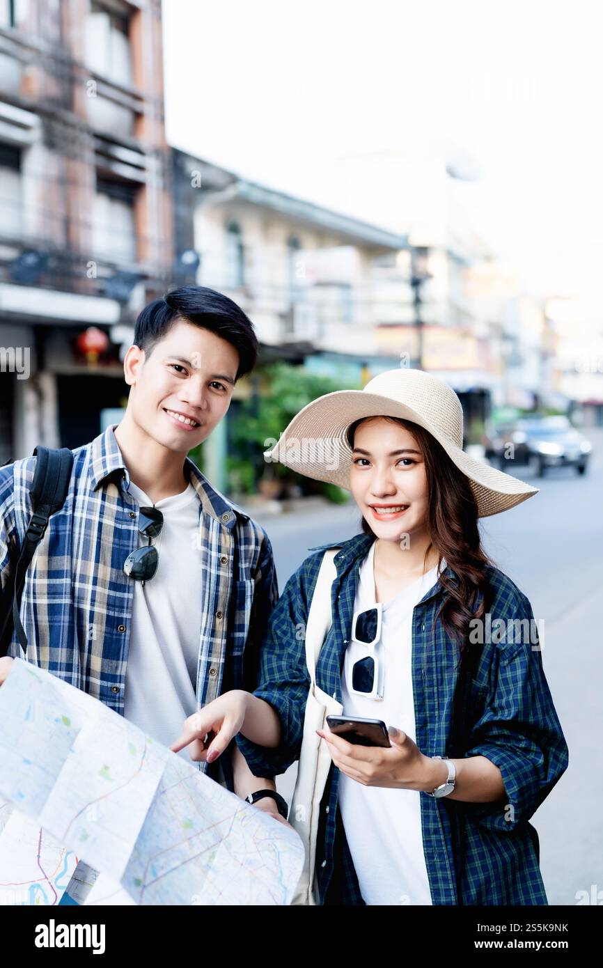 Young Backpacker Couple Hold paper Map and smartphone to checking ...