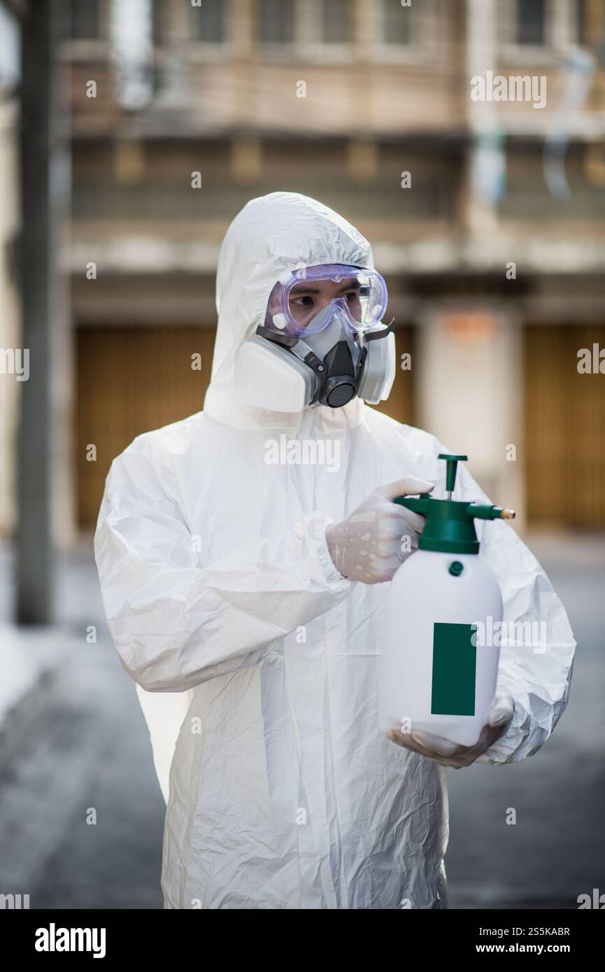 Disinfection specialist man in personal protective equipment (ppe) suit ...
