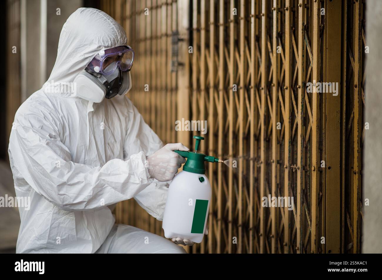 Disinfection specialist man wearing personal protective equipment (ppe ...