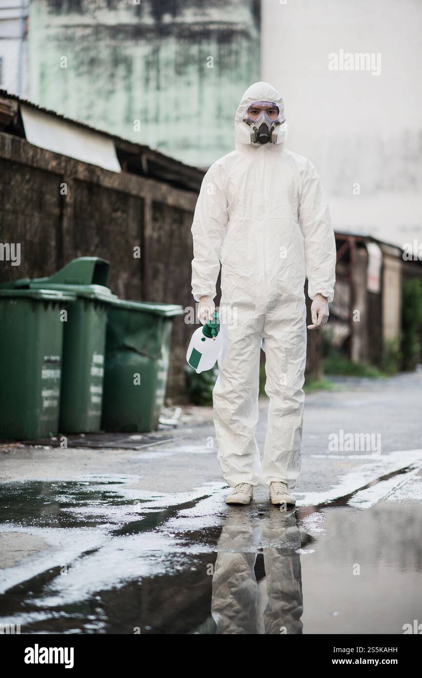 Disinfection specialist man in personal protective equipment (ppe) suit ...
