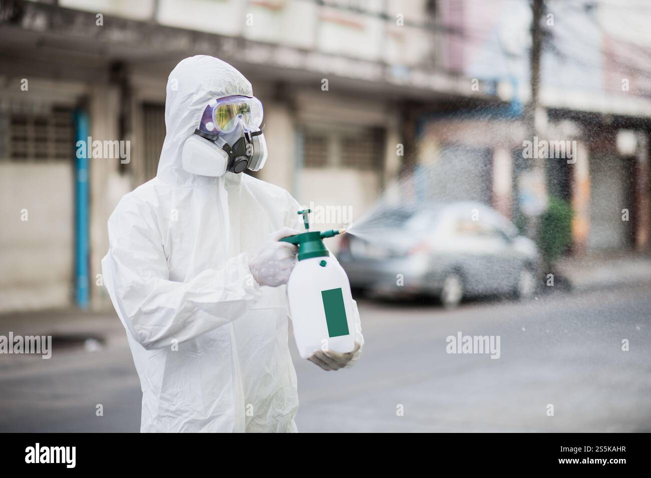 Disinfection specialist man in personal protective equipment (ppe) suit ...