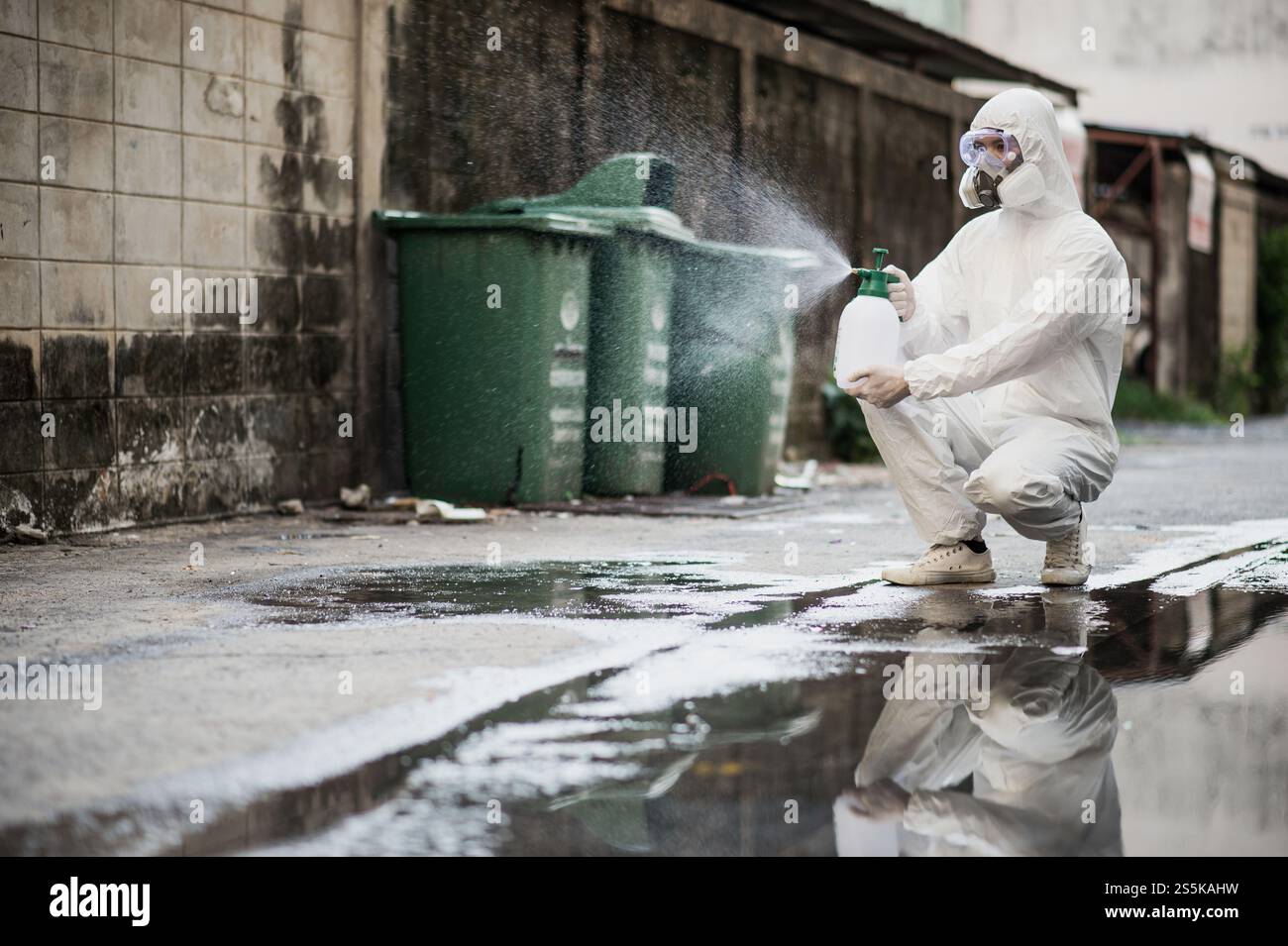 Disinfection specialist man in personal protective equipment (ppe) suit ...