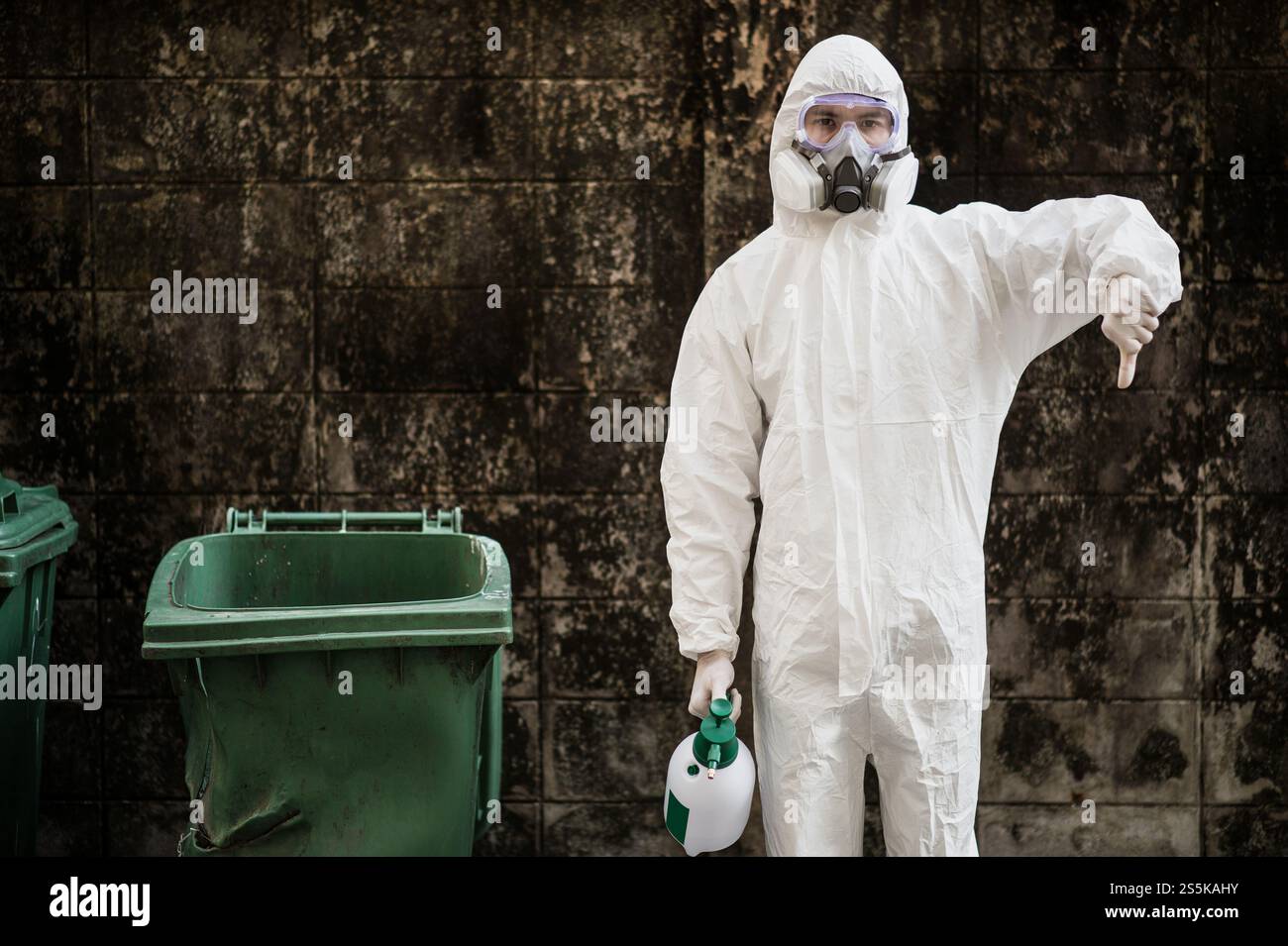 Portrait Disinfection specialist man in PPE suit, gloves, mask and face ...