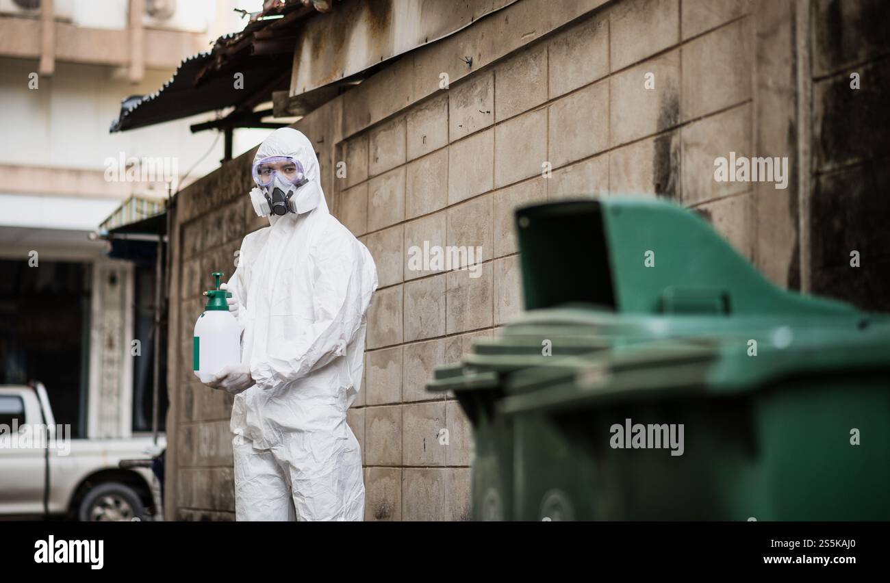 Disinfection specialist man in personal protective equipment (ppe) suit ...