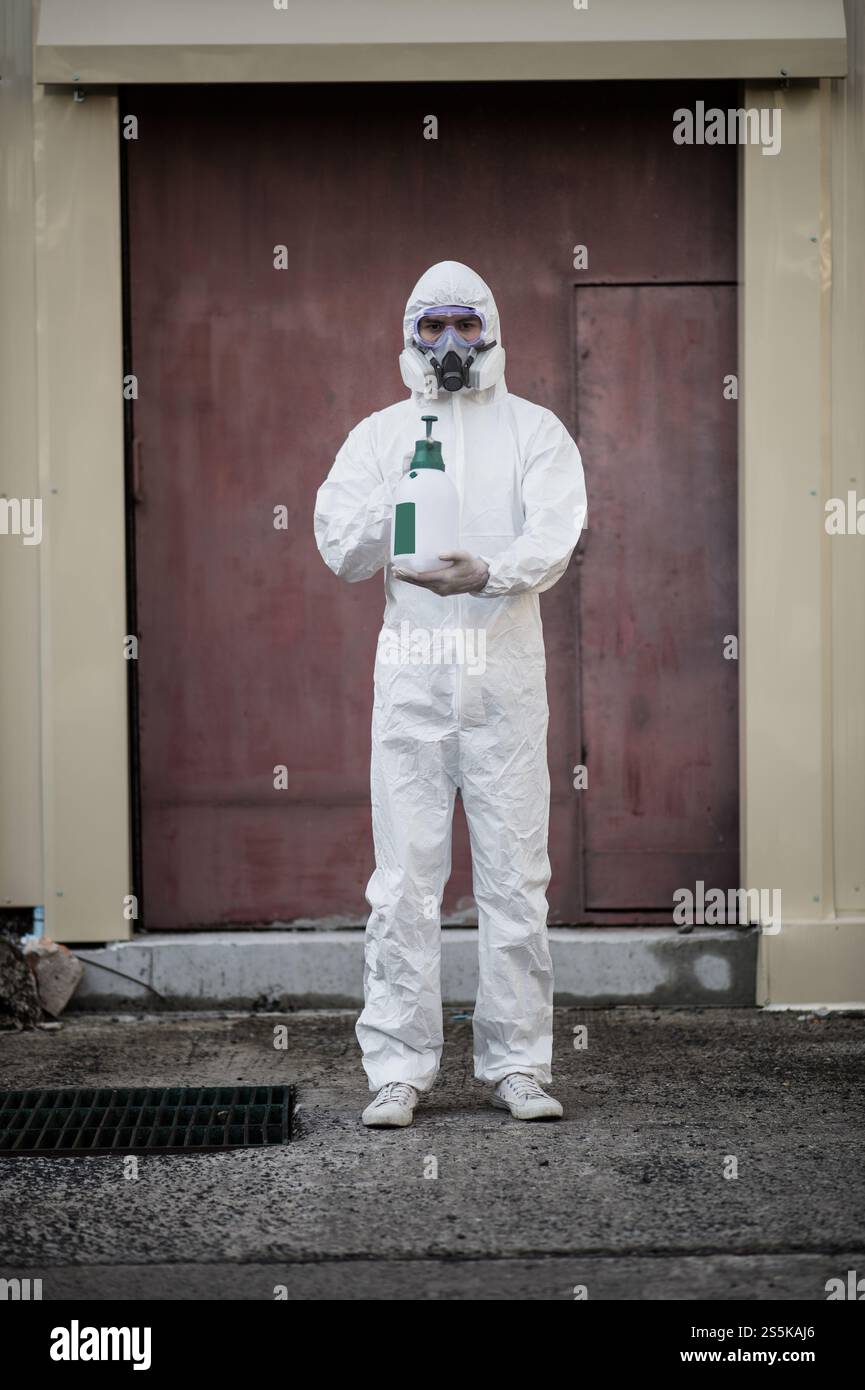 Portrait Disinfection specialist man in PPE suit, gloves, mask and face ...