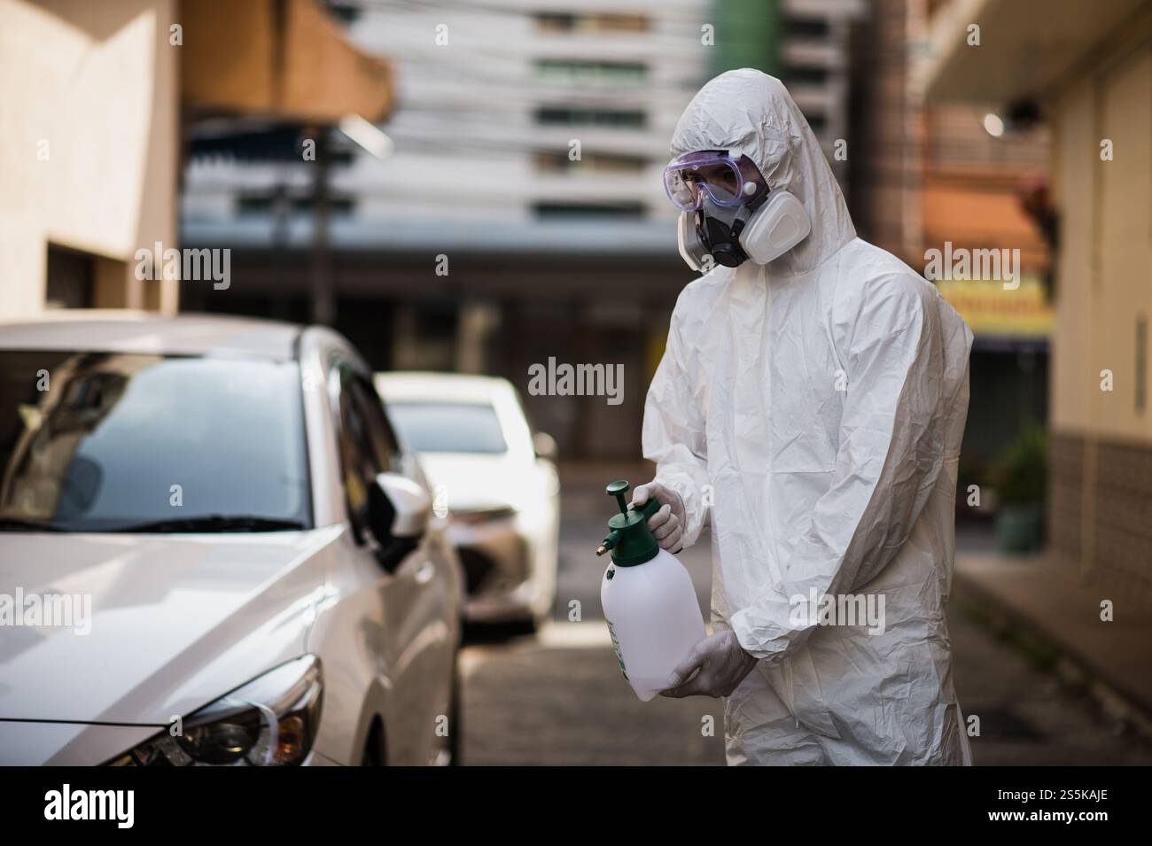Disinfection specialist man in personal protective equipment (ppe) suit ...