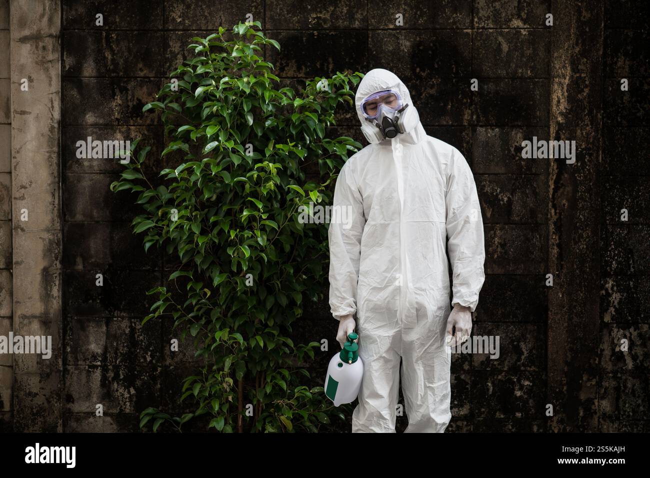 Portrait Disinfection specialist man in PPE suit, gloves, mask and face ...