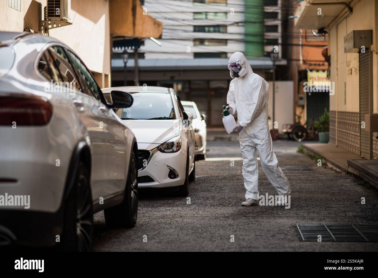 Disinfection specialist man in personal protective equipment (ppe) suit ...