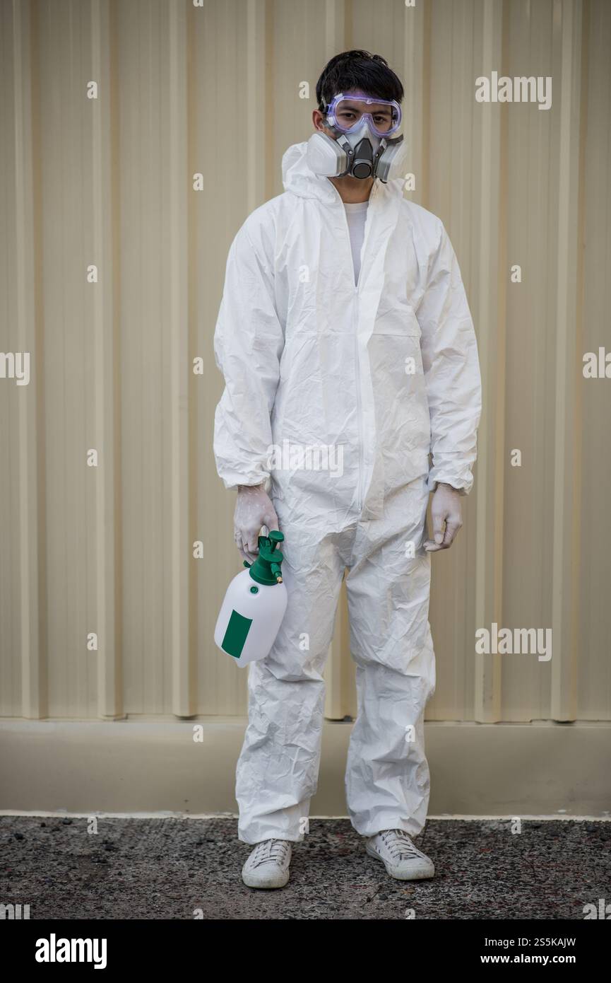 Portrait Disinfection specialist man in PPE suit, gloves, mask and face ...