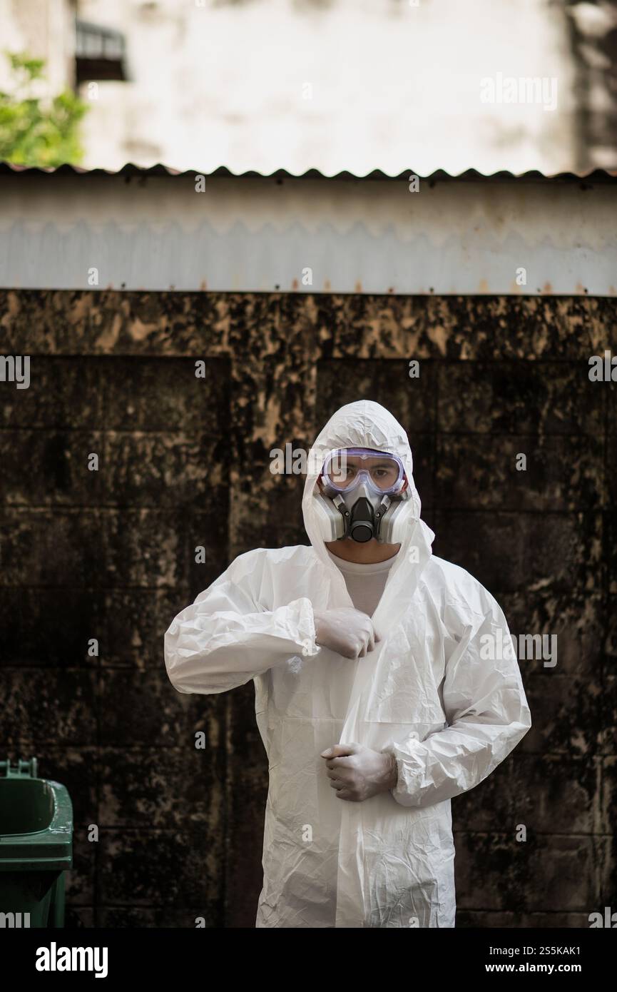 Man in personal protective equipment ppe suit wearing clear glasses and ...
