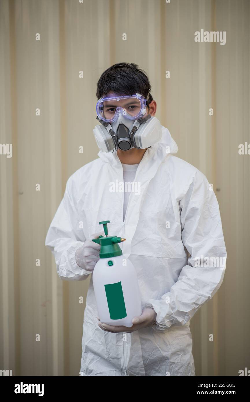 Portrait Disinfection specialist man in PPE suit, gloves, mask and face ...