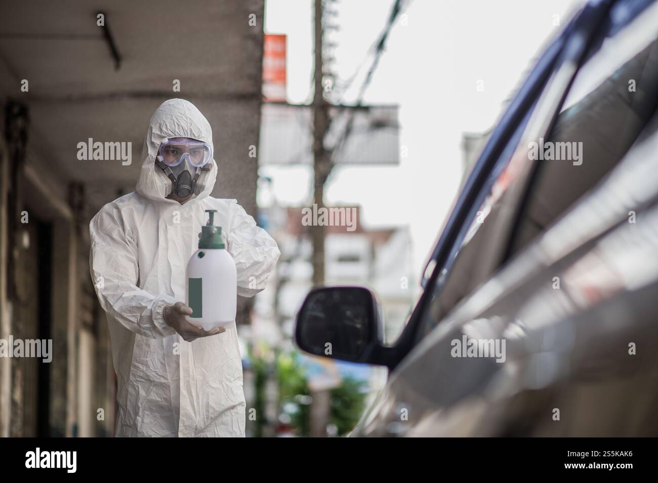 Disinfection specialist man in personal protective equipment (ppe) suit ...