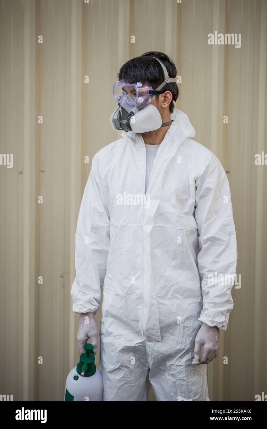 Portrait Disinfection specialist man in PPE suit, gloves, mask and face ...