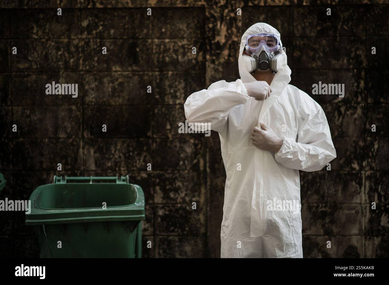 Man in personal protective equipment ppe suit wearing clear glasses and ...