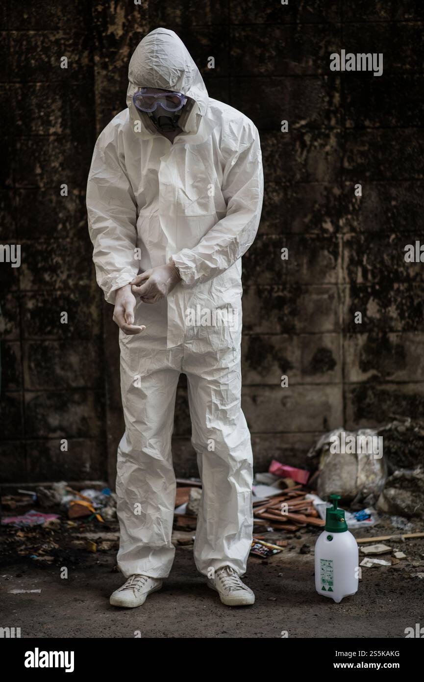 Man in personal protective equipment ppe suit wearing clear glasses and ...