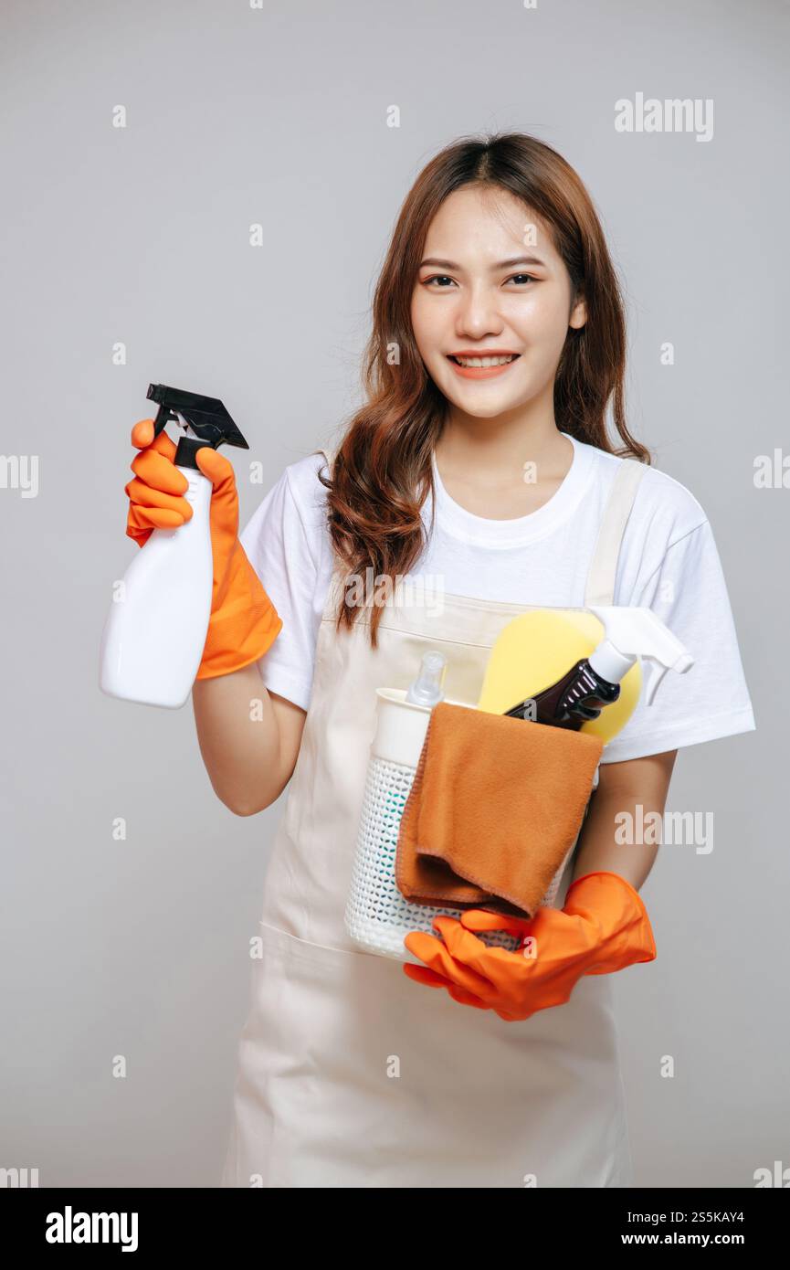 Portrait young asian woman in apron and rubber gloves, smile and ...