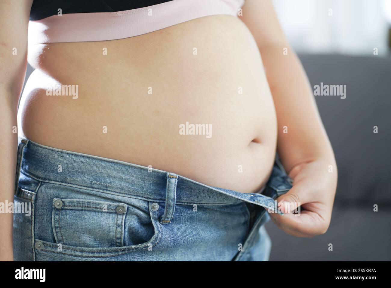 Mothercare. Pregnant woman measuring her belly growth of the baby ...