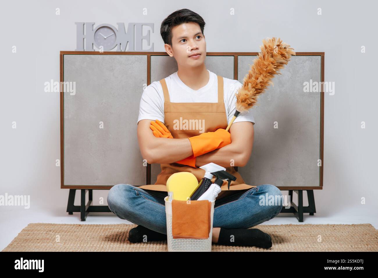 Portrait handsome man wearing apron and rubber gloves during cleaning ...