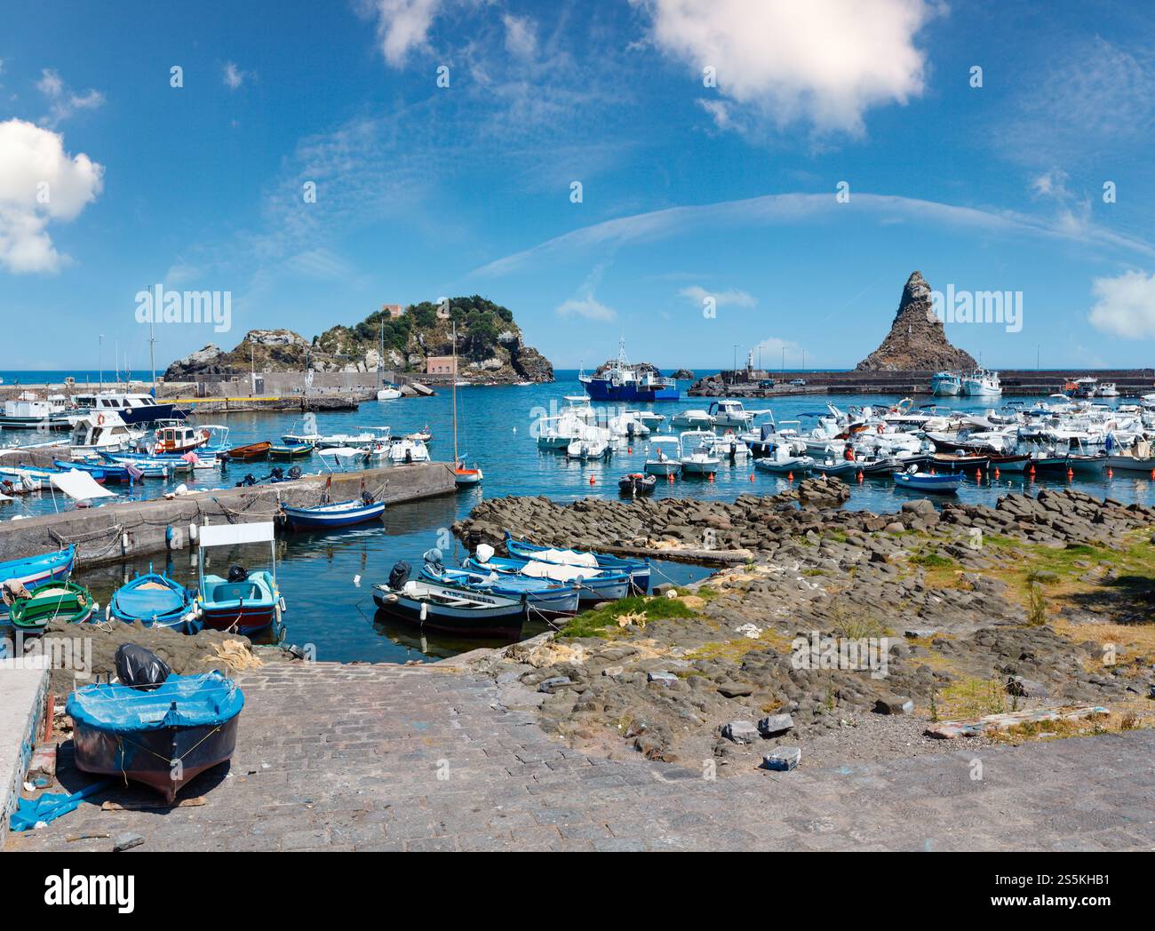 Aci Trezza Marina dei Ciclopi boats harbor. Lachea Island on Cyclopean ...