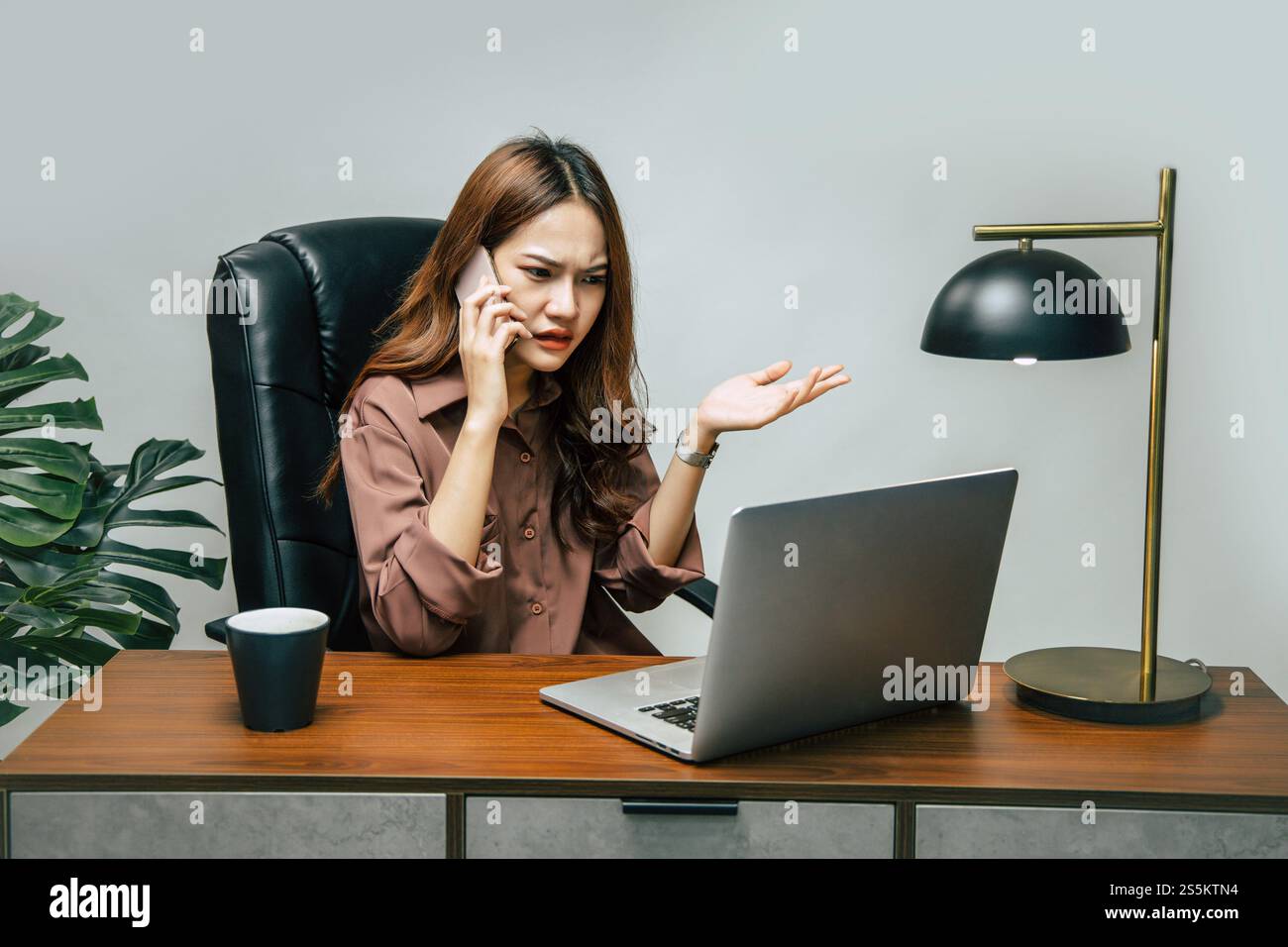Serious young asian businesswoman works hi-res stock photography and ...