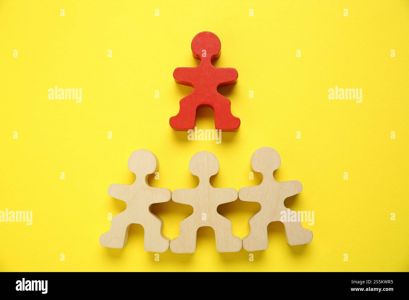 Personality test. Red human figure over wooden ones on yellow ...