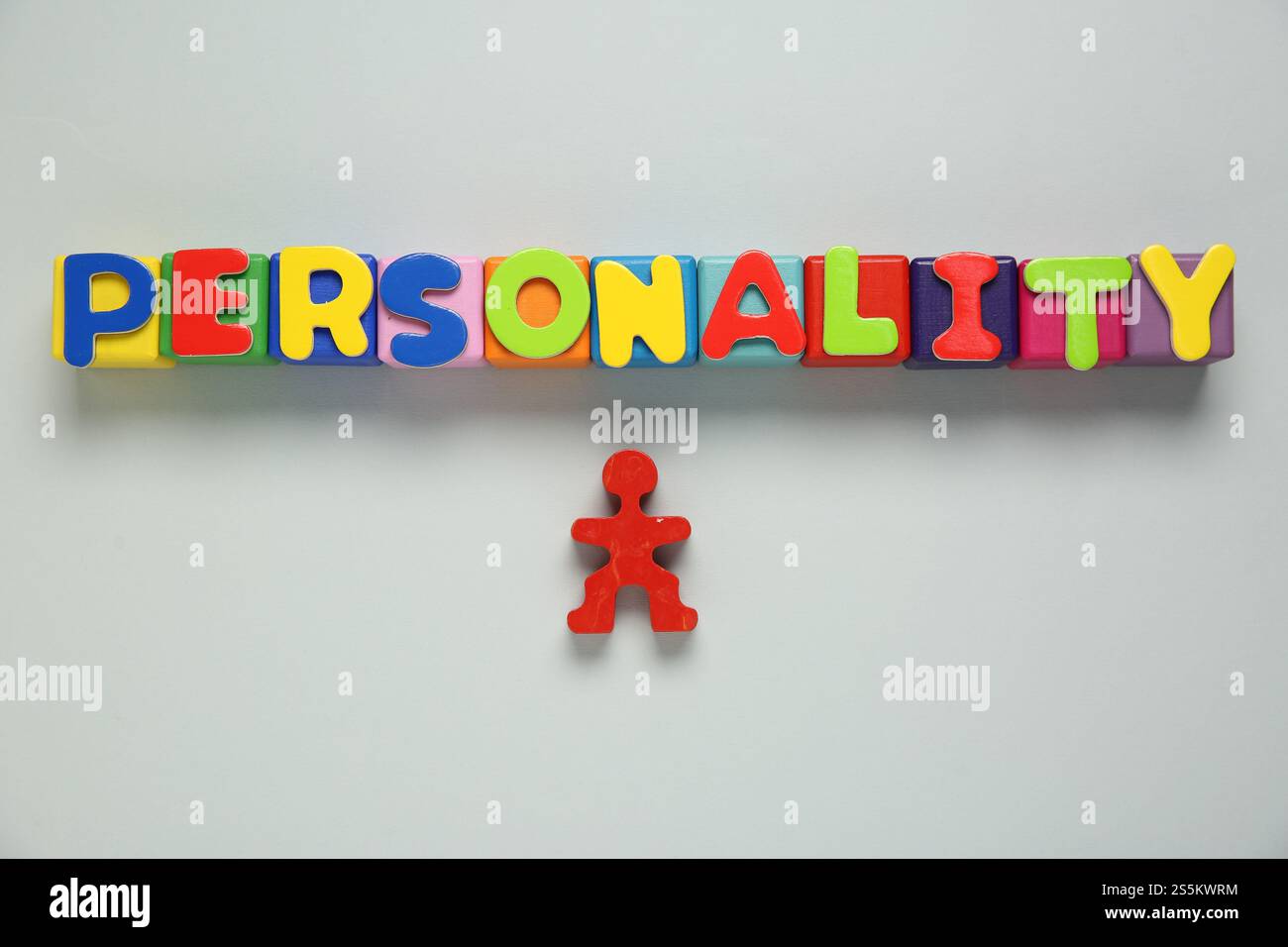 Word Personality made of colorful letters and red human figure on light ...