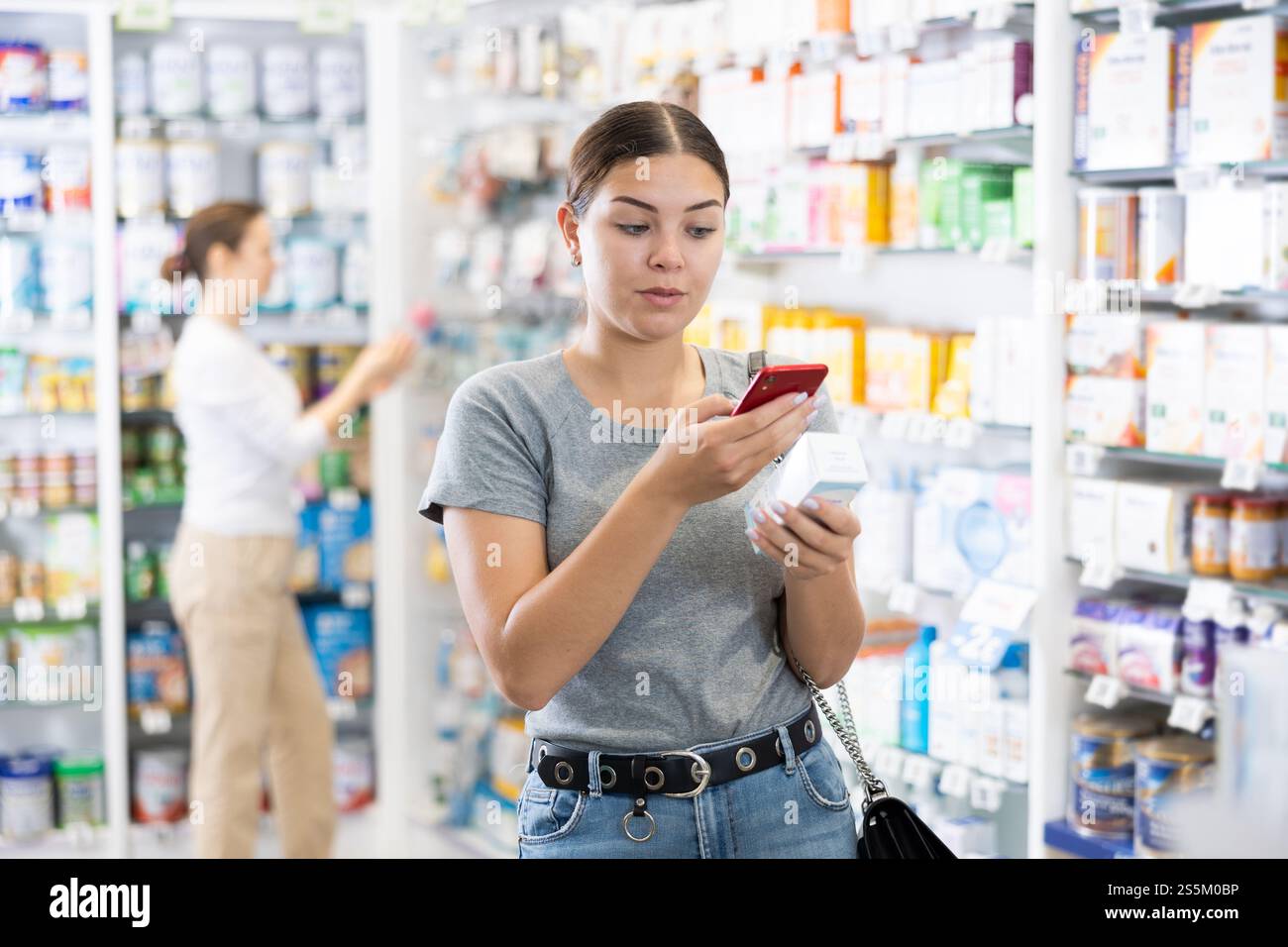 In pharmacy visitor scan QR Code and reads composition of cream for ...