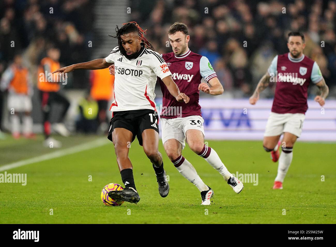 Fulham's Alex Iwobi (left) and West Ham United's Andy Irving battle for ...