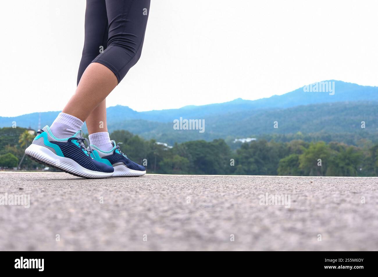 Athlete runner feet running on road Stock Photo - Alamy