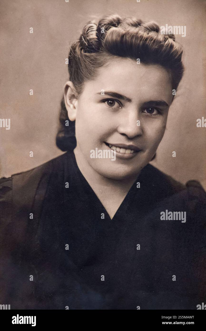 Vintage portrait of a smiling woman with braided hair wearing a dark ...