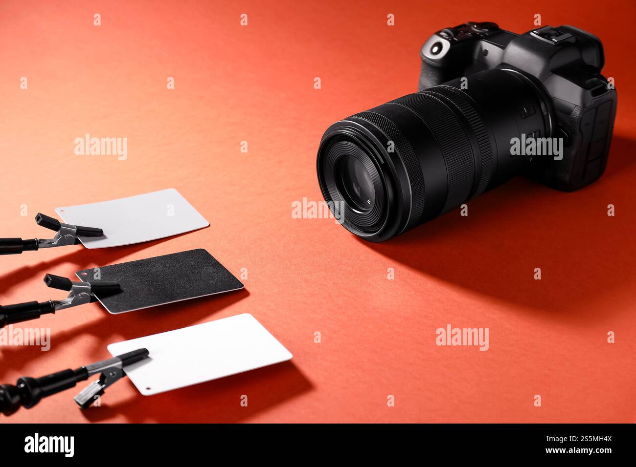 White balance calibration cards and camera on red background Stock ...